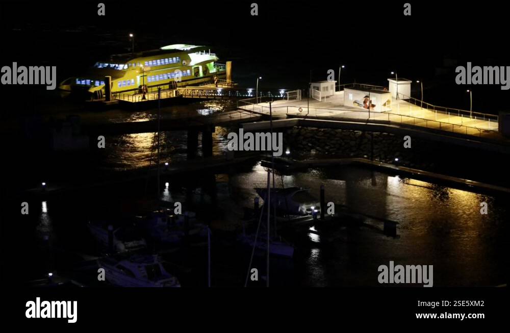 Ferry docking at night Stock Video Footage - Alamy