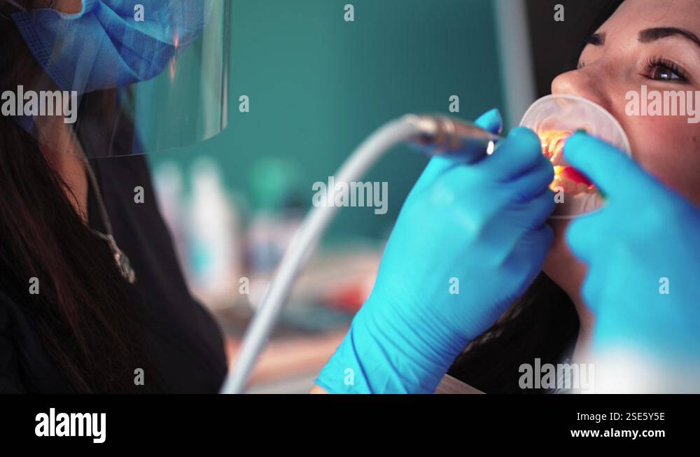 Woman Dentist with Assistant Does Brushing Teeth Female Patient in ...