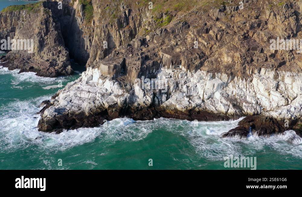 Drone fly over ocean wave crash on the island cliff Stock Video Footage ...