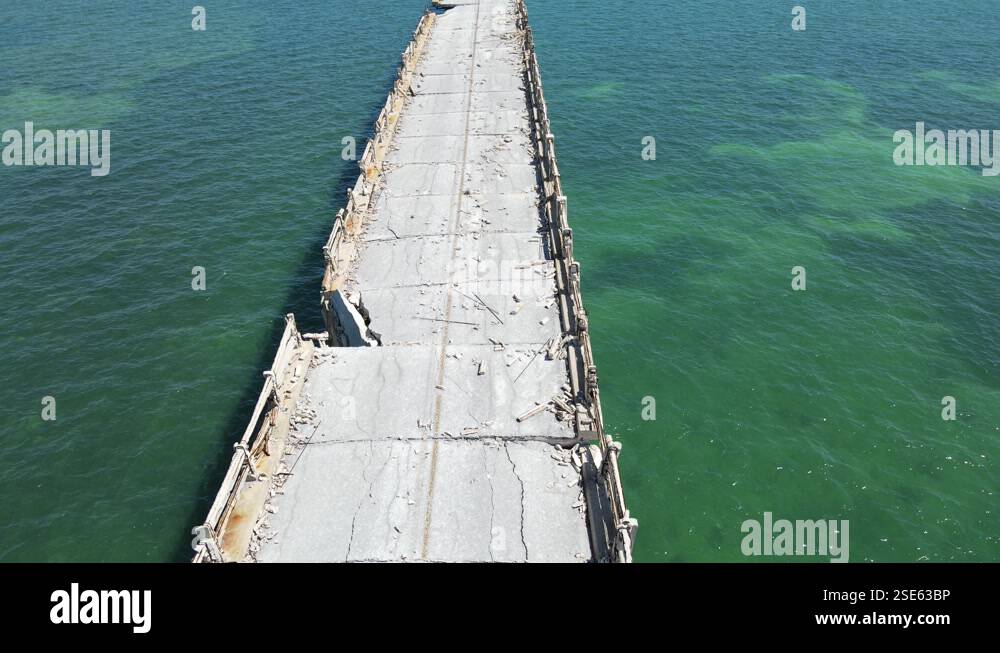 Large missing chunks of concrete and broken cement railing show the ...