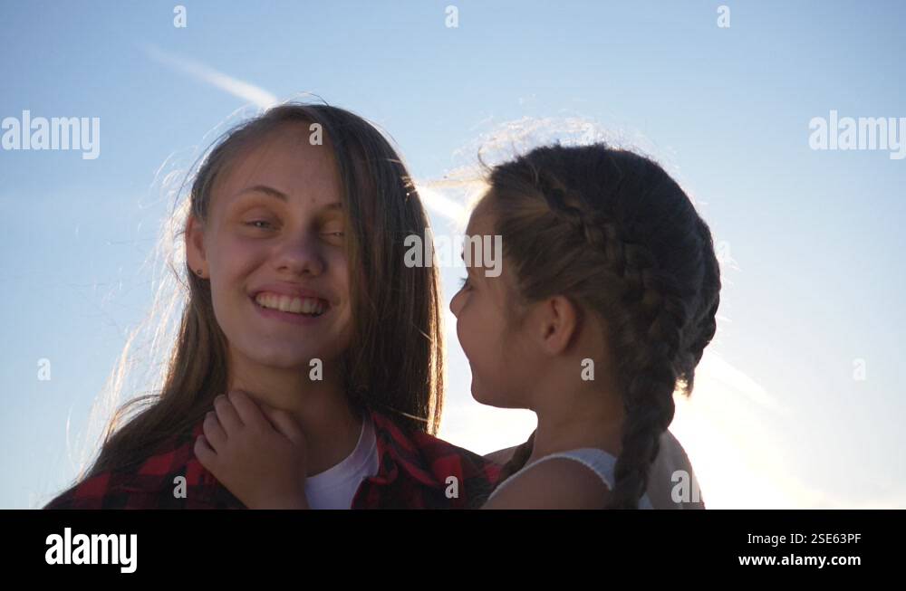 Little happy family. Silhouette of happy kid girl hugging little sister ...