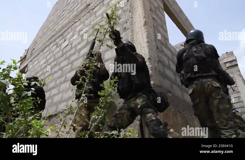 Ghanaian Special Forces soldiers patrolling and clearing derelict ...