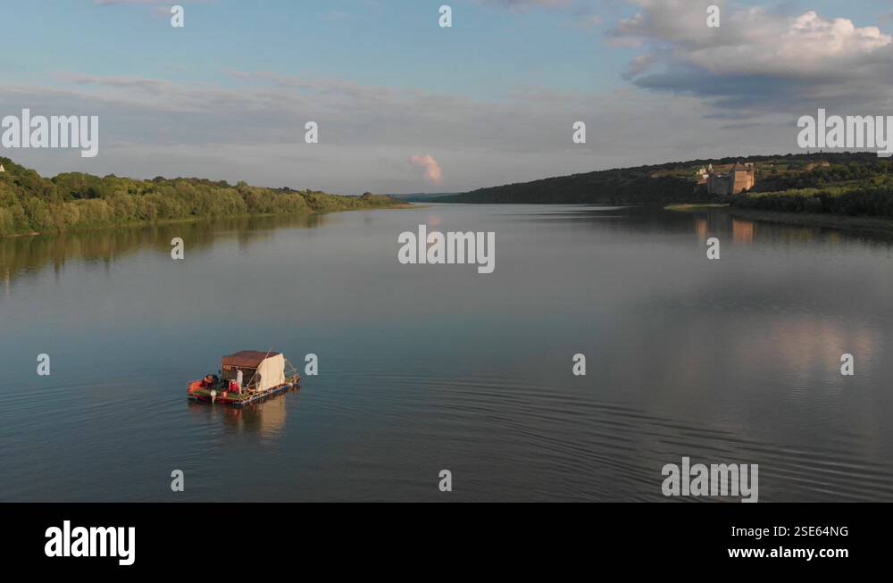 Raft floating on a river in front of a medieval castle Stock Video ...
