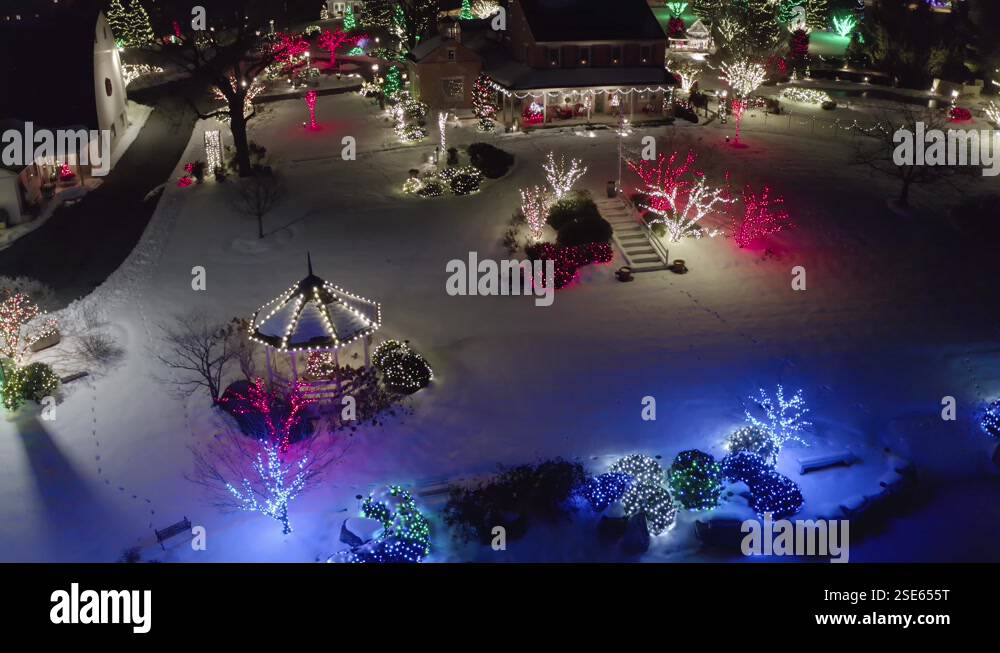 Aerial tilt up reveals home estate decorated with Christmas lights and ...