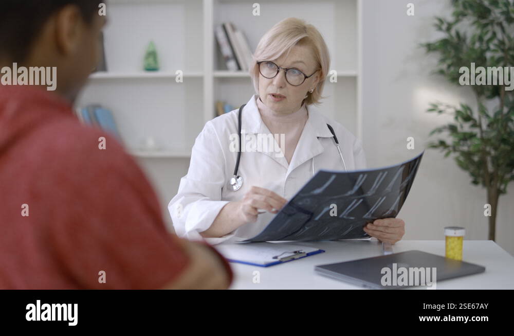 Trauma doctor checking patients x-ray image, successful bone fracture ...