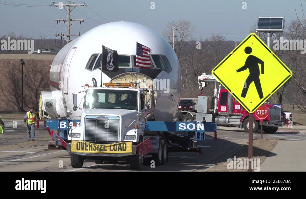 Truck turning while towing oversize load of 767 Fuselage Stock Video ...