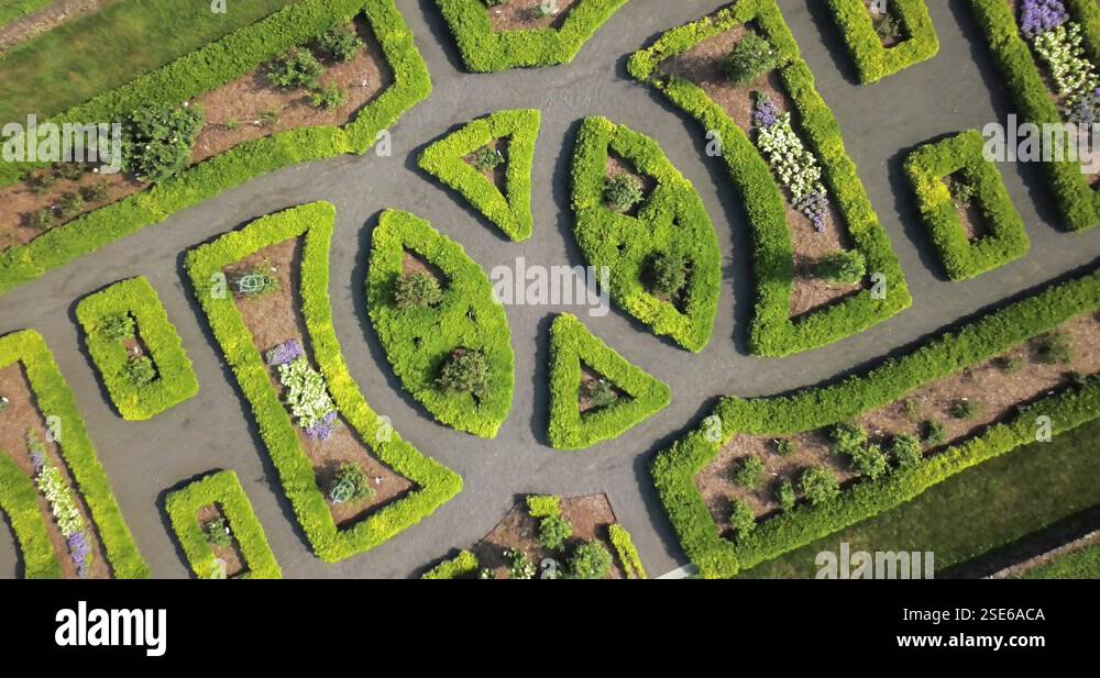 Quick drone landing in direct center of symmetrical green park in ...