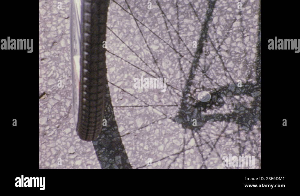 1970s: Bikes ride in line, bike stops, zoom in on tire. Zoom in on bike ...