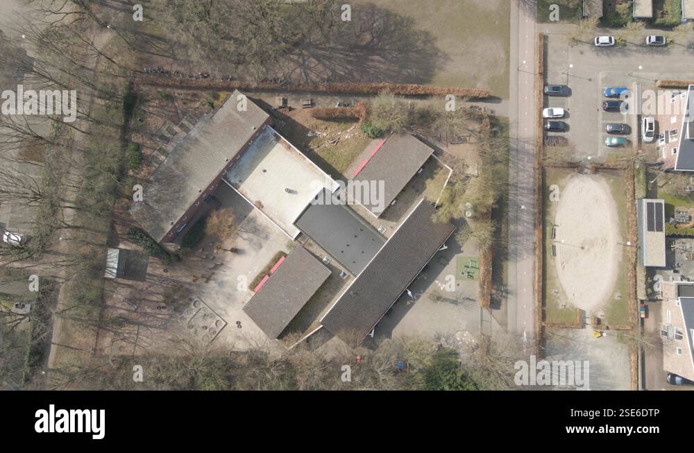 Top down aerial of children playing on grade school playground - drone ...