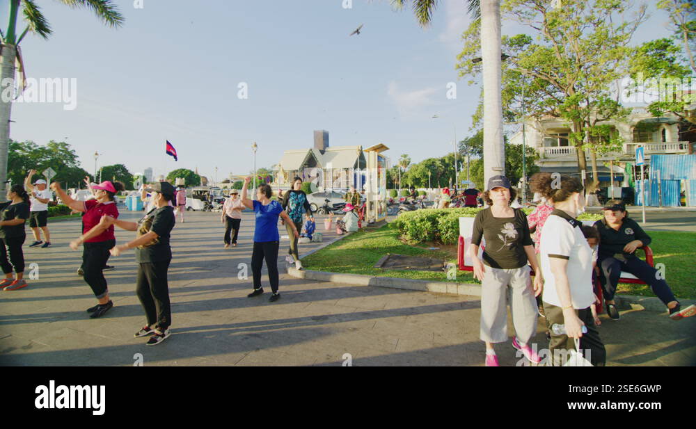 Women Line Dancing Along The Tonle Sap River In Phnom Penh, Cambodia ...