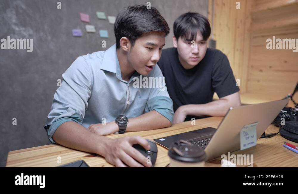 A young active male programmer explaining his ideas to colleague at ...