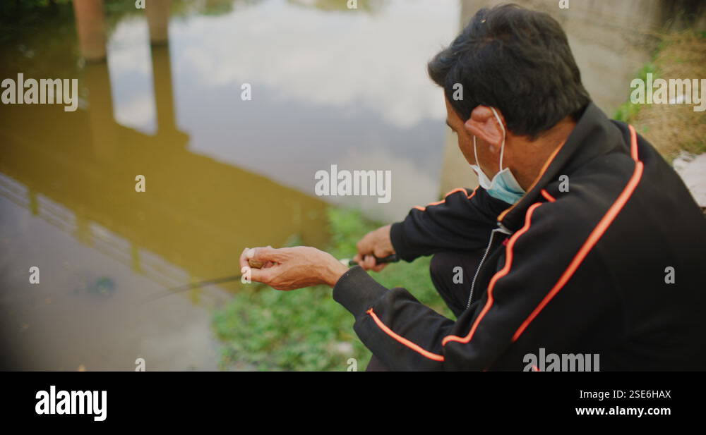 Man Fishing Along The Siem Reap River in Siem Reap, Cambodia Stock ...