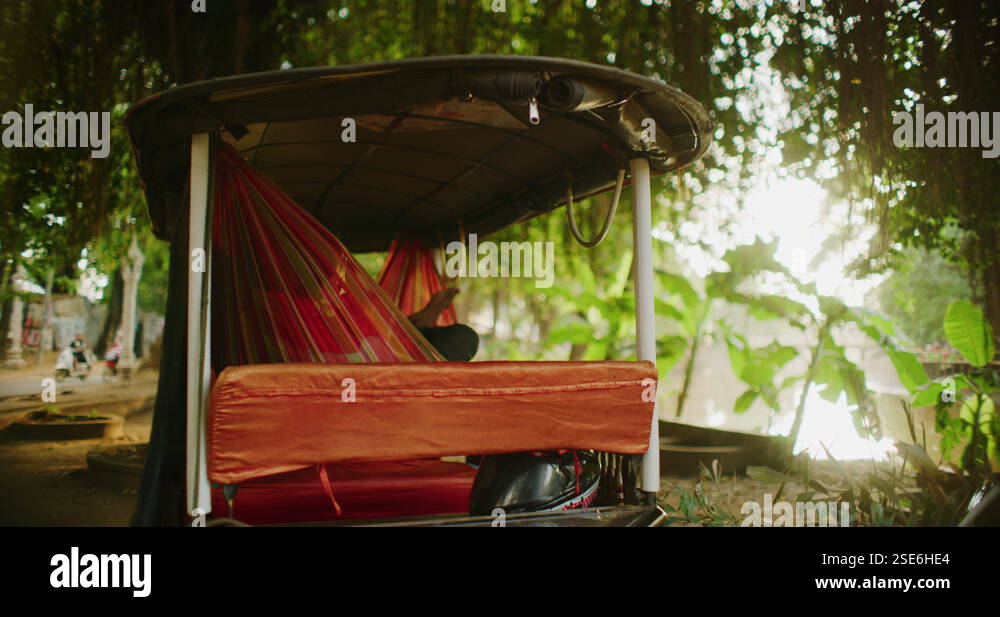 Man Relaxing In His Rickshaw Along The Siem Reap River in Siem Reap ...