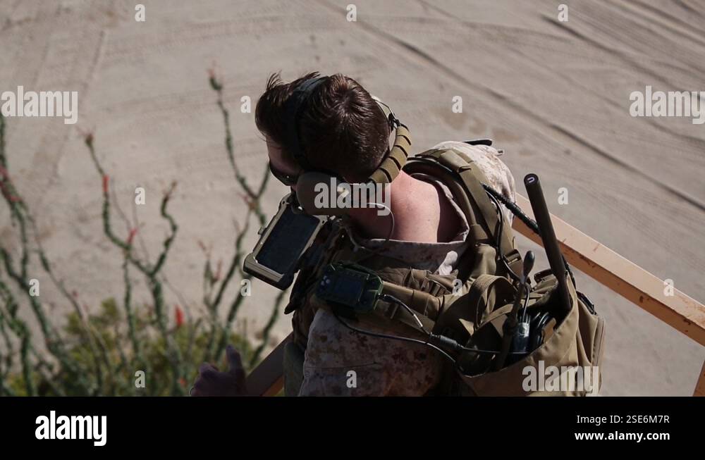 US Marines looking at screen of handheld computer during Close air ...