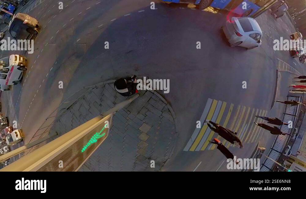 Traffic at a busy intersection captured by a 360-degree camera, time ...