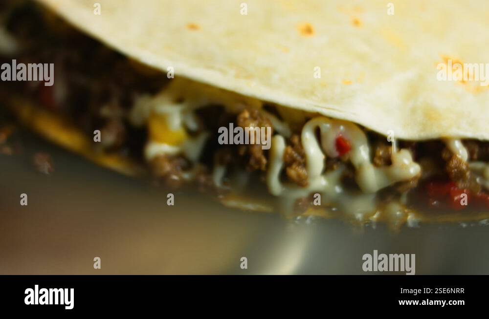 Frying a freshly wraped beef quesadilla on a frying pan. Process of ...