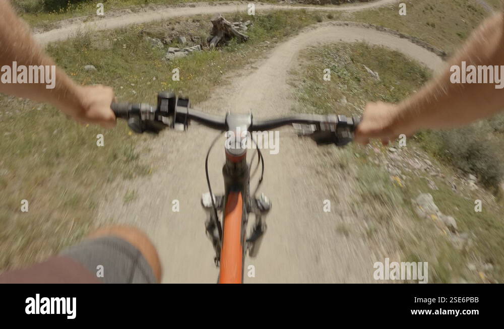 Point of view, mountain biker descending trail in the woods. Mountain ...
