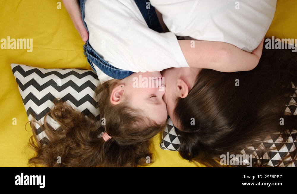 Adorable small child girl embrace mum cuddling enjoy tender sweet ...