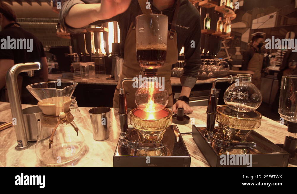 Barista making coffee with syphon at Starbucks coffee shop in Bangkok ...