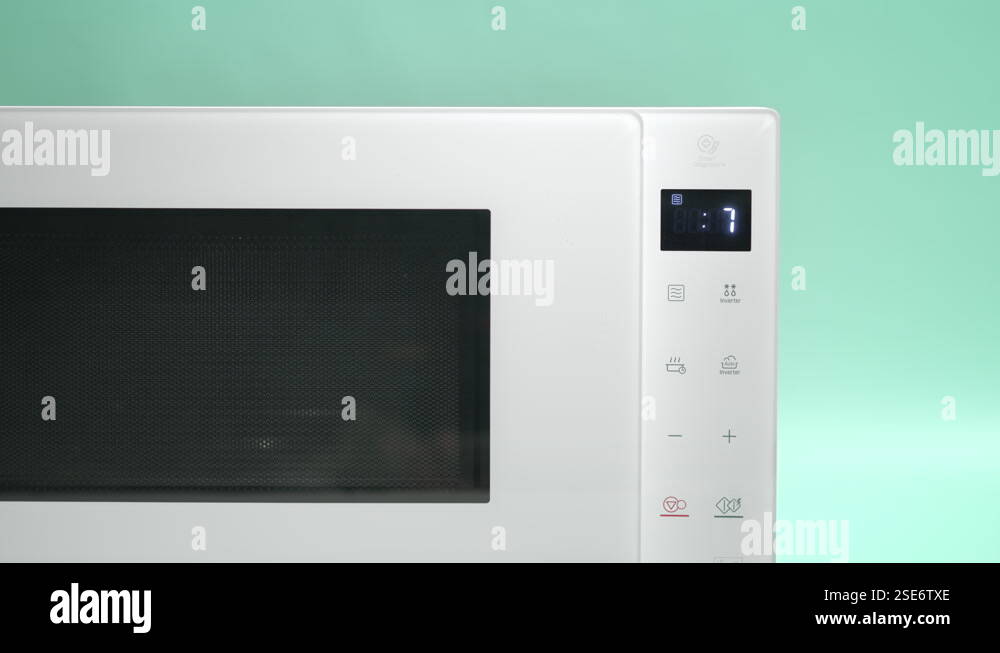 Digital microwave timer counting down from nine.Close up of part of ...