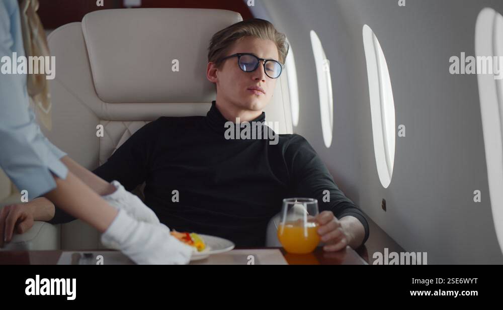 Stewardess serving meal for male passenger in first class Stock Video ...