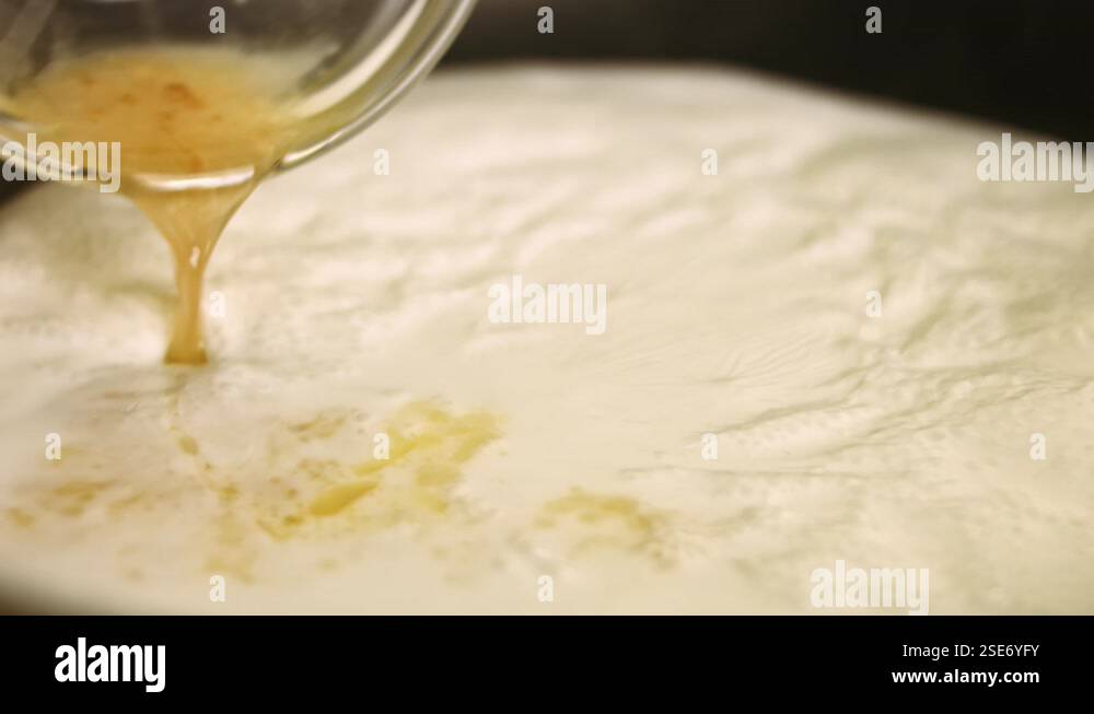 Adding melted chicken fat to mixed milk and water boiling in a frying pan Stock Video Footage ...