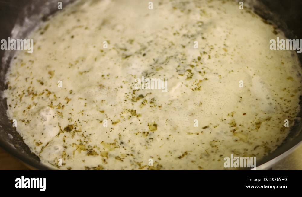 Preparing the sauce for oven roasted chicken. Sauce boiling in a frying ...