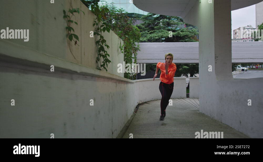 ACTIVE womana running in downtown at night in urban environment Stock ...