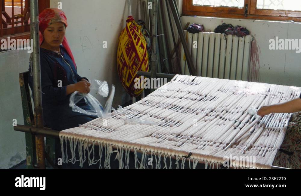 Uyghur women working together as a team for dying silk threads for the Stock Video Footage - Alamy