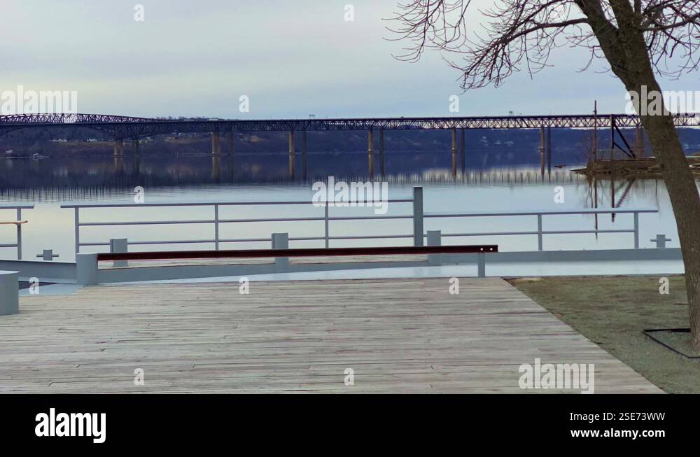 A large wooden dock patio overlooking the Hudson River and toward the ...