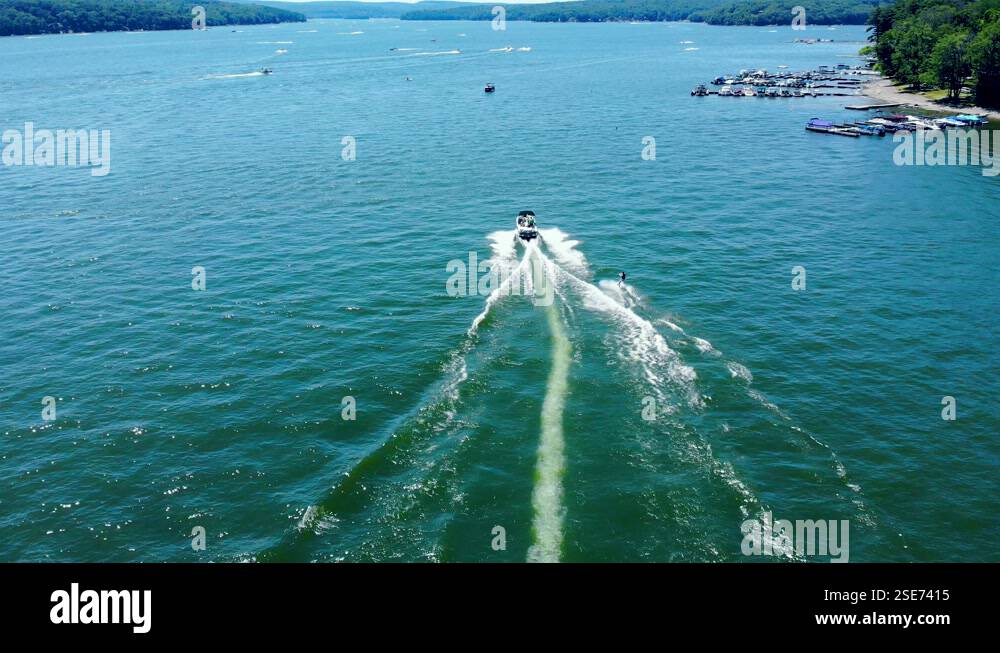 Birds eye view of tourists enjoying water skiing, tied behind high ...