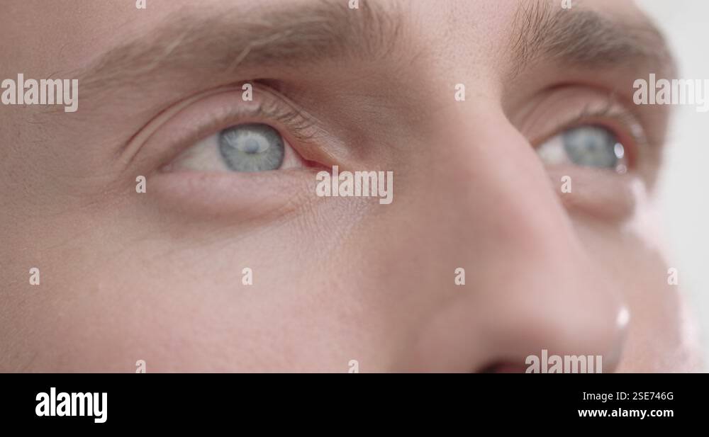 Close up of beautiful Man Blue azure Eyes looking up on White ...