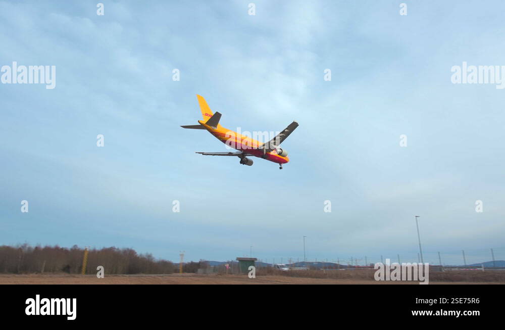 dhl cargo airplane airbus A300 passing overhead panning right wide ...