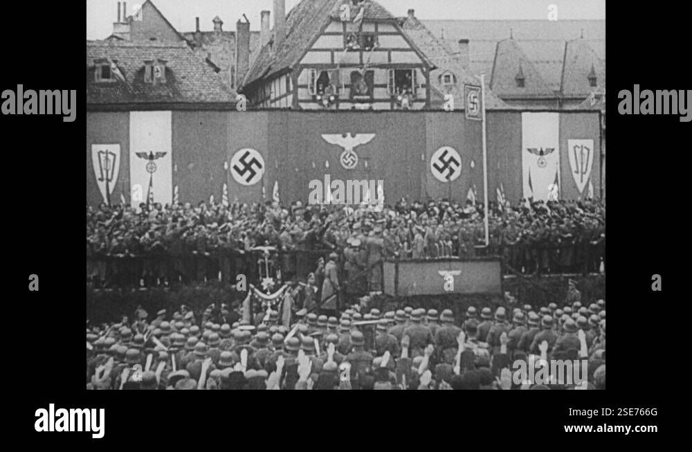1930s: People in city street give Nazi salute. Adolph Hitler and ...