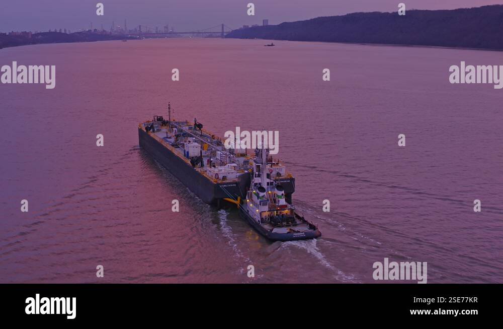 Flying over huge oil barge and tug on Hudson river at dusk, Yonker ...