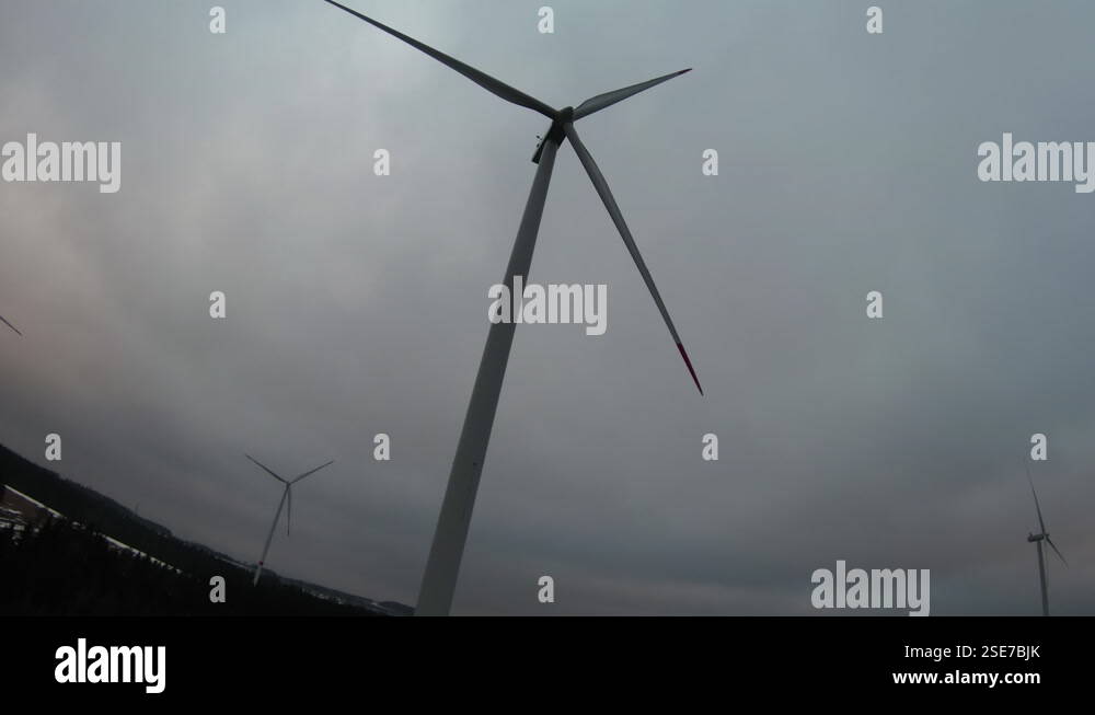 Wind Turbine Spinning Under Cloudy Sky Low Angle FPV. Alternative ...