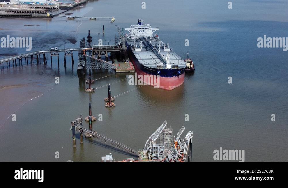 Crude oil tanker ship loading at refinery harbour terminal aerial view ...