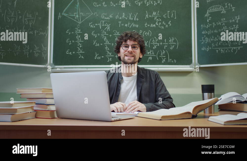 Teacher looks at camera talking at webcam say hello to students in ...