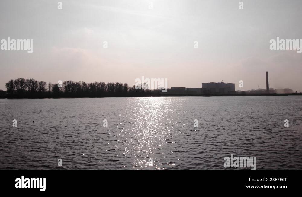 Glimmering Sunlight On Rippling River Water Overlooking Town Of Stock ...