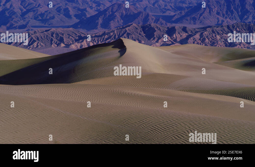 8K golden sand dunes with shades and rocky mountains in Death Valley ...