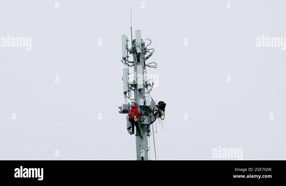 Electricians are doing repairs on network tower poles to install and ...