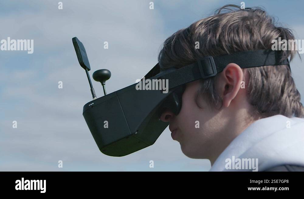 Teenage boy flying FPV acrobatic drone. Close up of a young man Stock ...