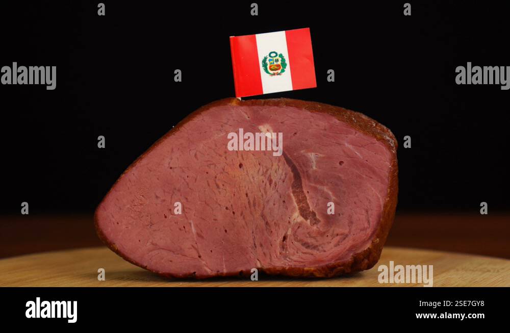 Person placing decorative Peruvian flag toothpicks into piece of red ...