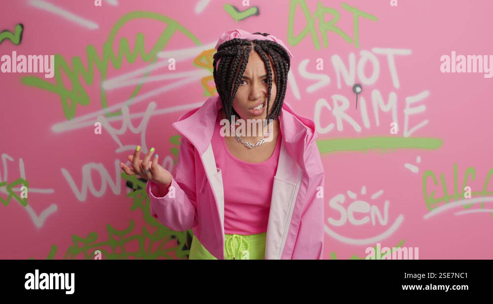 Funky crazy African American woman looks with irritated face expression ...