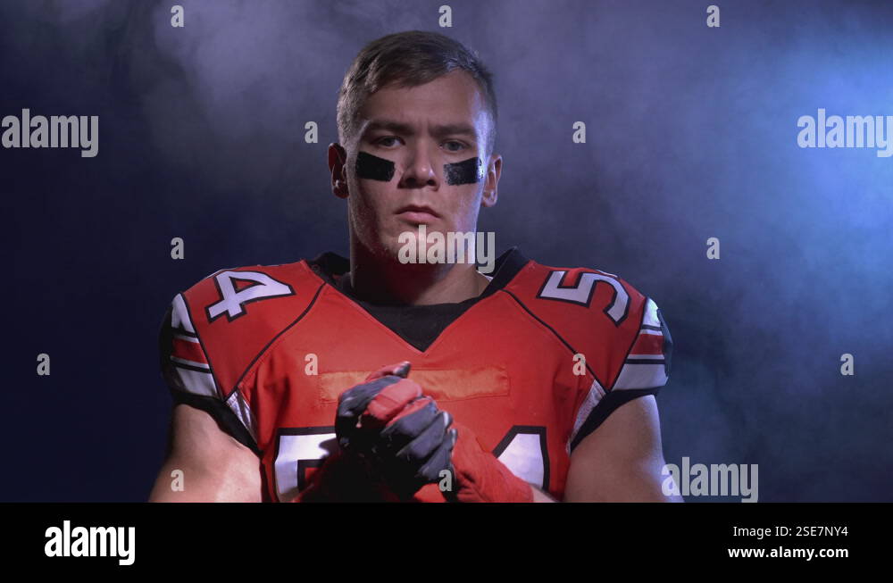 Portrait of determined serious professional American football player in ...