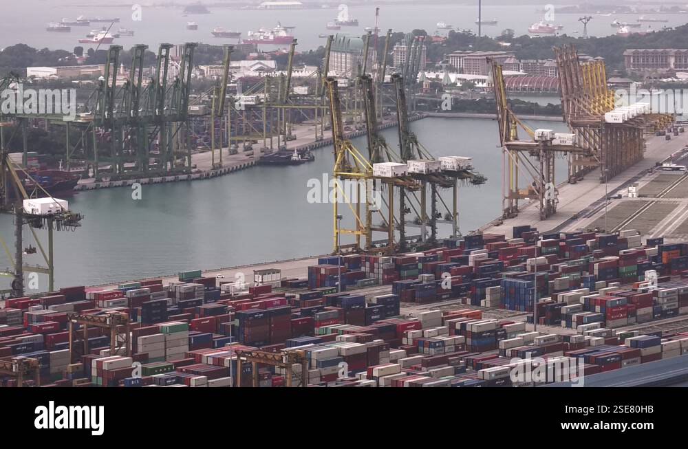 Shipyard crane loading bridge and ship containers in Singapore harbour ...