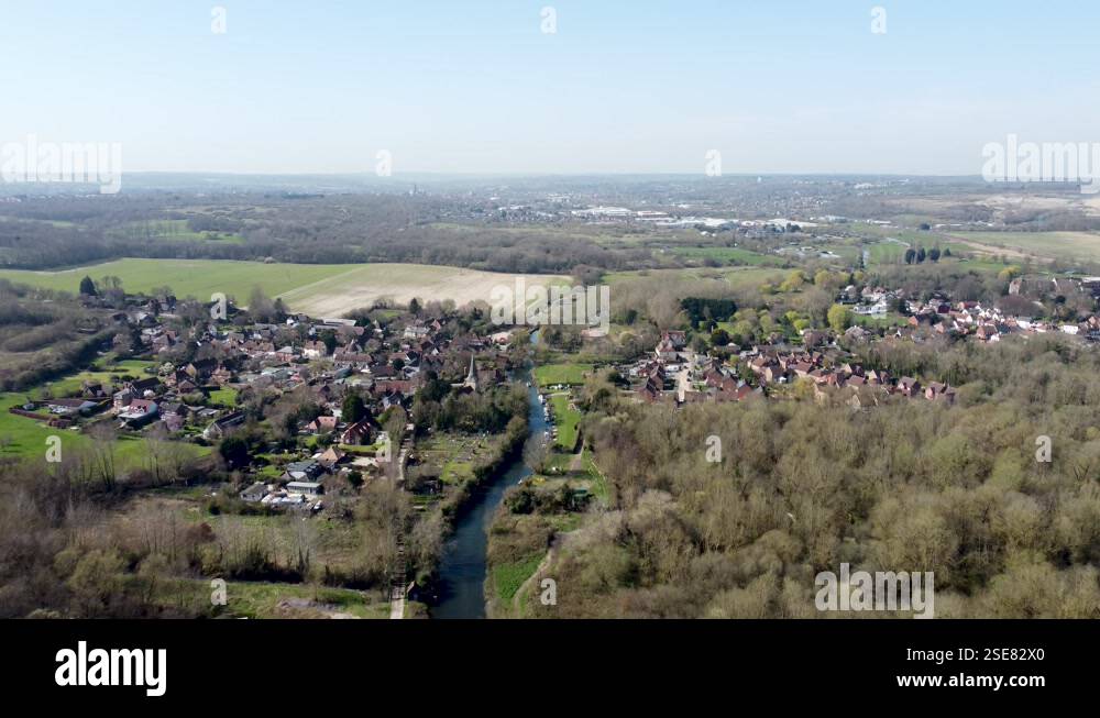 Drone flies over the River Great Stour towards the small village ...