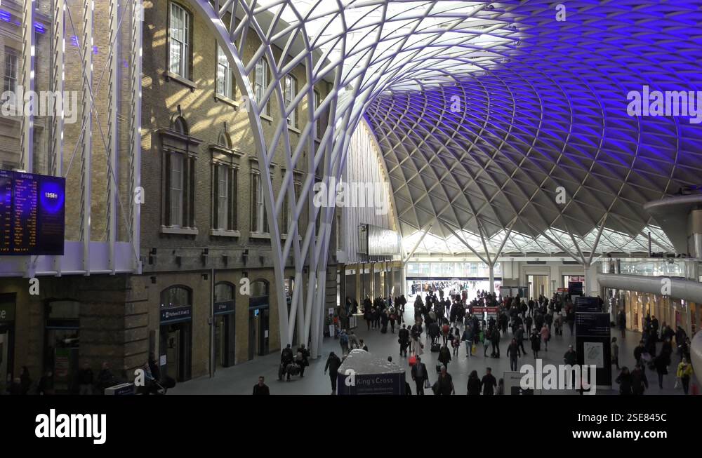 Inside the station. There are a lot of passengers in the hall. London ...