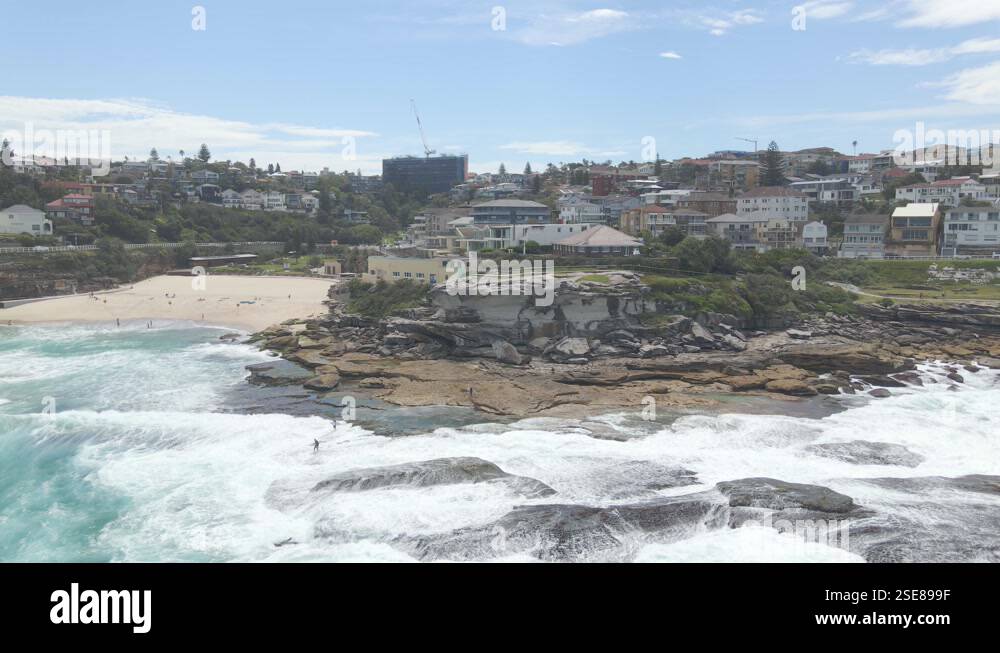 Dangerous Waves Over Rocky Shore With Surfers At Tamarama Point ...