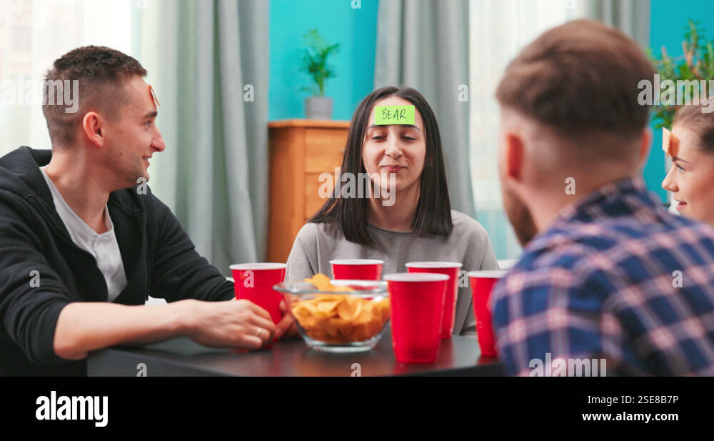 In the Living Room Diverse Group of Fun Loving Friends Playing Who am I ...